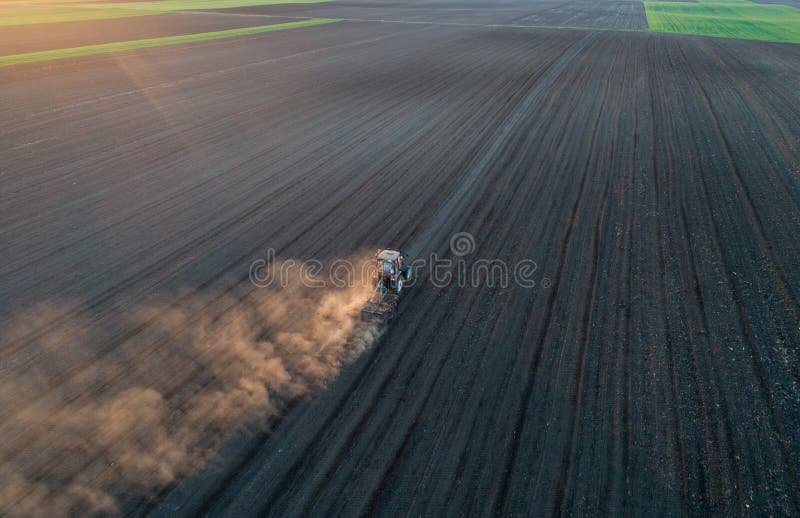 Tractor harrowing soil stock photo. Image of agricultural - 89881862