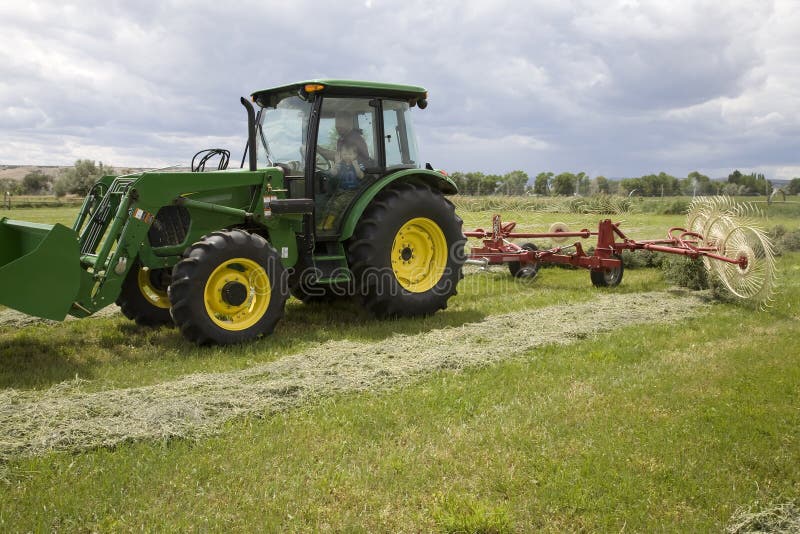 Tractor with hay rake editorial image. Image of field - 10401880