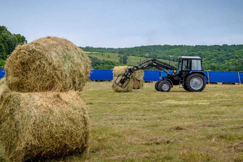 Tractor Hay Stacks in the Field Stock Image - Image of harvesting ...