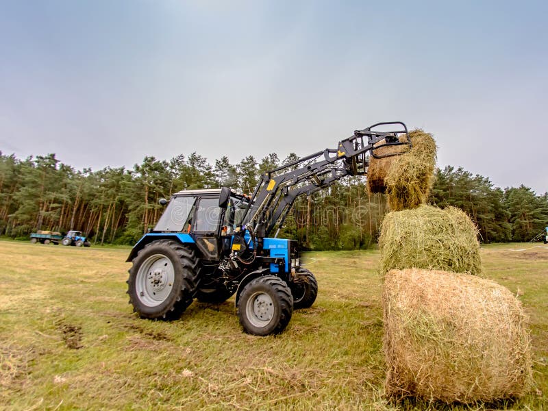 Tractor Hay Stacks in the Field. Toning Stock Image - Image of grass ...
