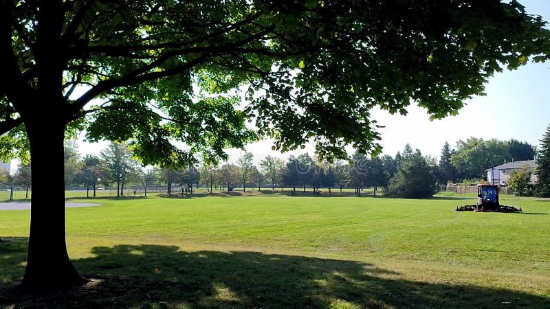 Tractor Lawn Mower Cutting the Grass in the Public Park Stock Footage ...