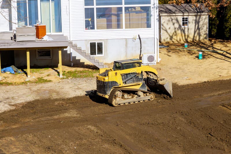 Tractor Levels Ground during Construction Work in a Backyard As Part of ...
