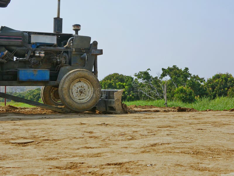 A Tractor Mounted with Front Grader is Preparing an Entrance Ramp ...