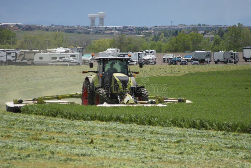A Tractor Mowing a field stock photo. Image of machines - 186875220