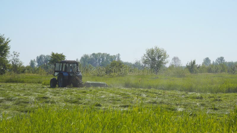 Tractor Mowing a Field in a Park Stock Video - Video of outside, cloud ...