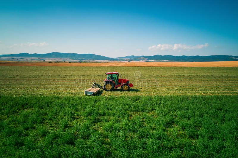 Tractor mowing green field stock image. Image of nature - 163582255