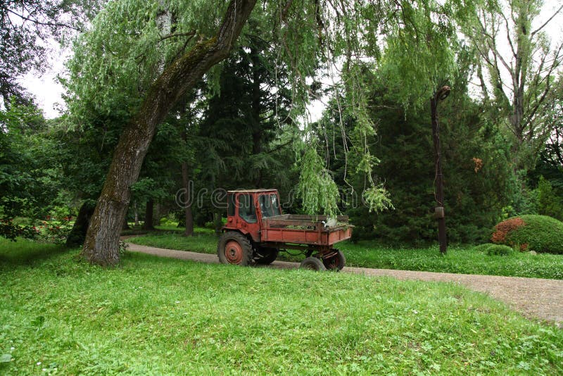 A tractor in a park stock photo. Image of mowing, drive - 140649288