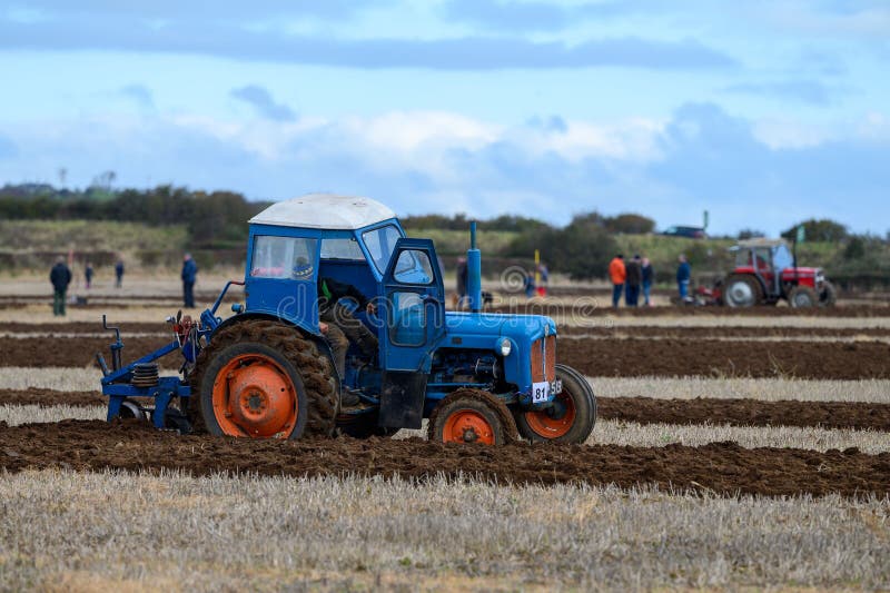 A Tractor that is Parked in a Field in the Dirt Stock Photo - Image of ...