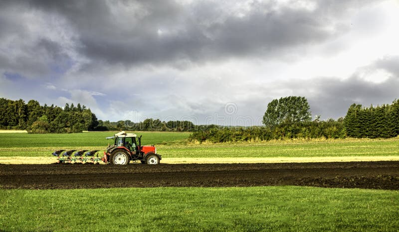 Tractor and plow in field stock photo. Image of agriculture - 33276626