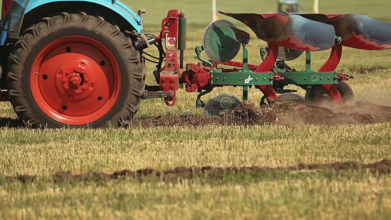 Tractor with Plow Plowing the Land and Making Stock Footage - Video of ...