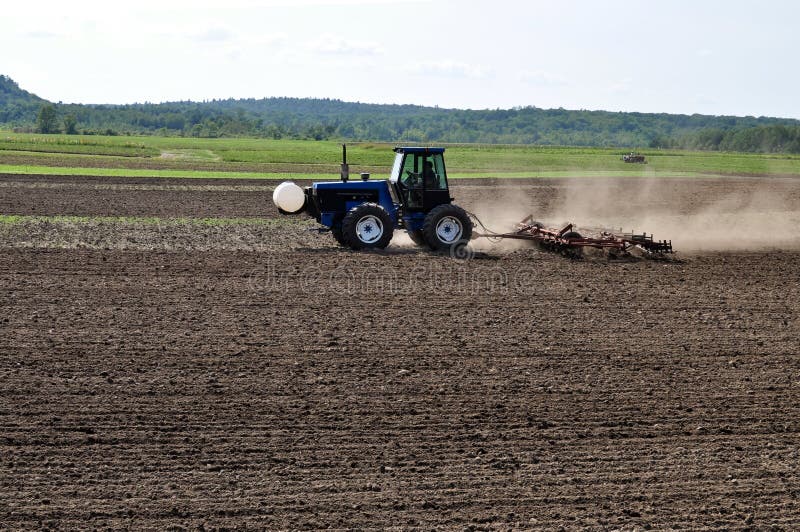 Tractor plowing a field stock image. Image of agriculture - 16200215
