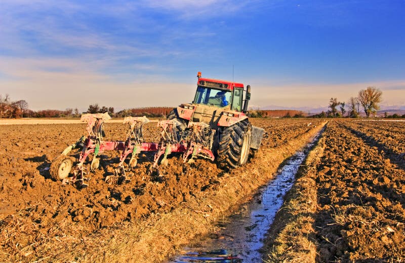 Tractor plowing field stock photo. Image of furrow, irrigate - 3678992