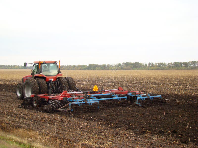 Tractor plowing a field stock image. Image of cultivator - 79122459