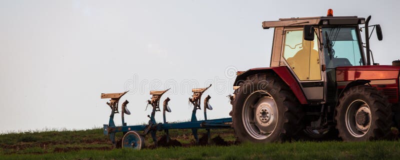 Tractor plowing a field stock photo. Image of farming - 78378076
