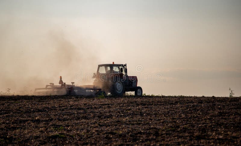 Tractor Plowing Field at Sunset Stock Photo - Image of farmland ...