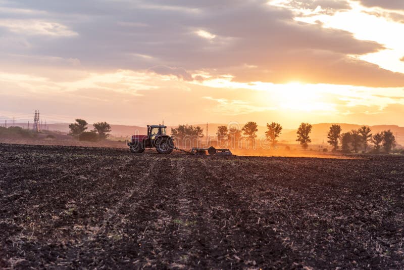 Tractor plowing fields stock image. Image of arable - 165440855