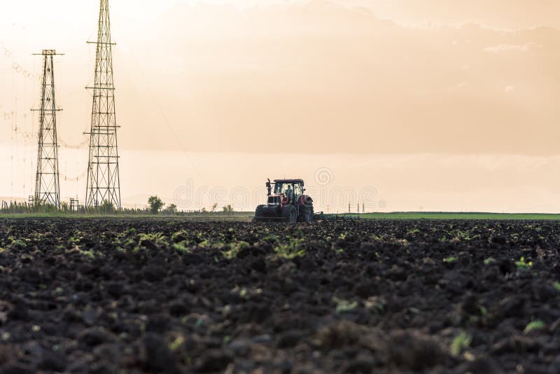 Tractor plowing fields. stock image. Image of arable - 123069625