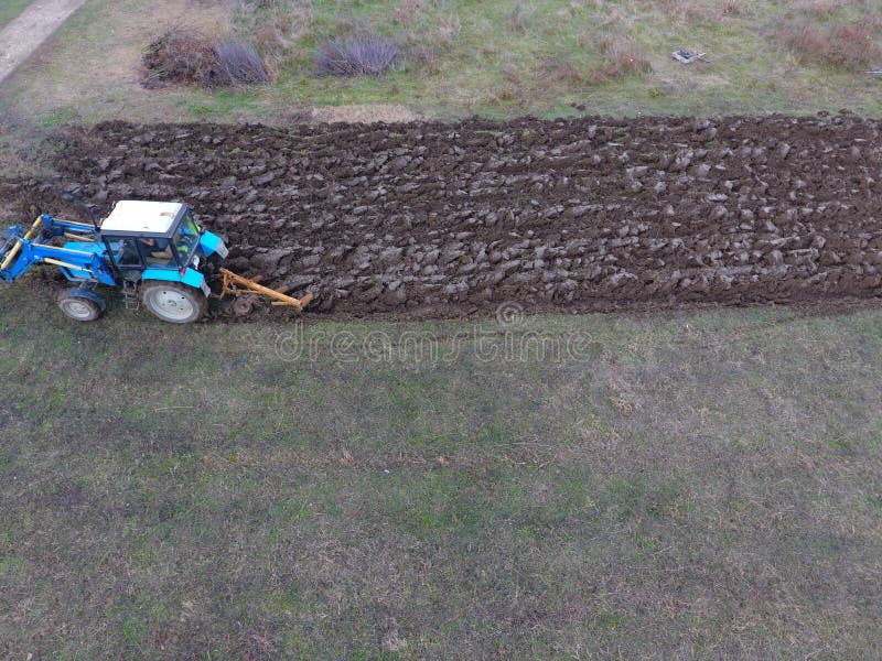 Tractor Plowing the Garden. Plowing the Soil in the Garden Stock Image ...