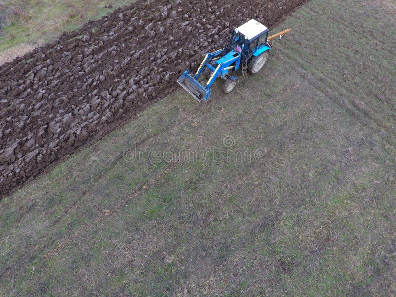 Tractor Plowing the Garden. Plowing the Soil in the Garden Stock Image ...