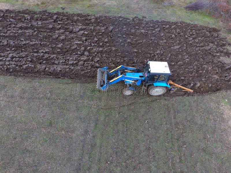 Tractor Plowing the Garden. Plowing the Soil in the Garden Stock Image ...
