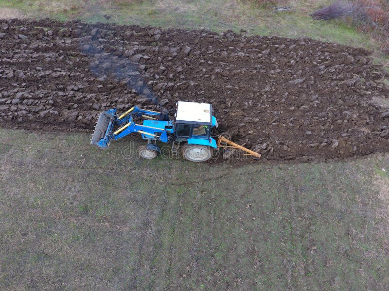 Tractor Plowing the Garden. Plowing the Soil in the Garden Stock Photo ...