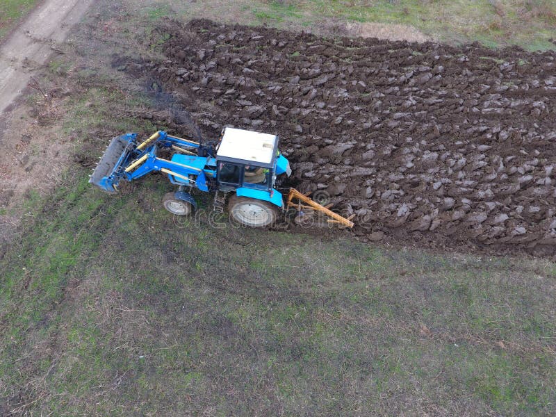 Tractor Plowing the Garden. Plowing the Soil in the Garden Stock Image ...