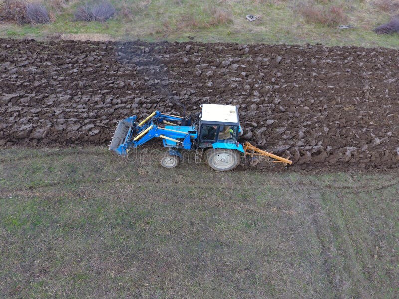 Tractor Plowing the Garden. Plowing the Soil in the Garden Stock Photo ...