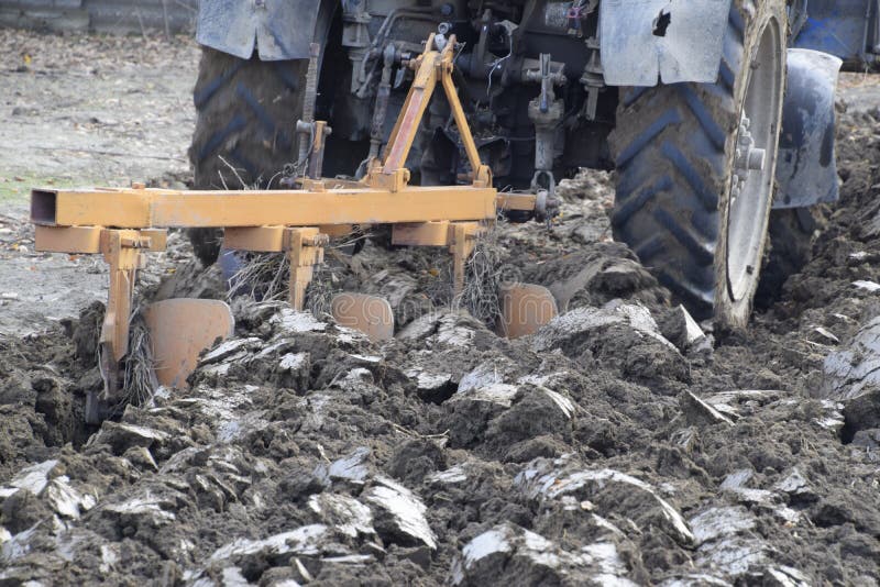 Tractor Plowing the Garden. Plowing the Soil in the Garden Stock Photo ...