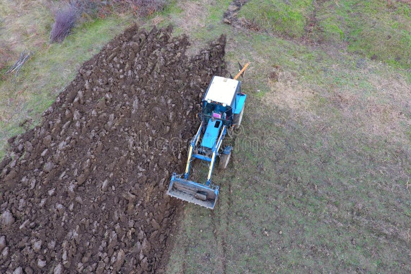 Tractor Plowing the Garden. Plowing the Soil in Stock Photo - Image of ...