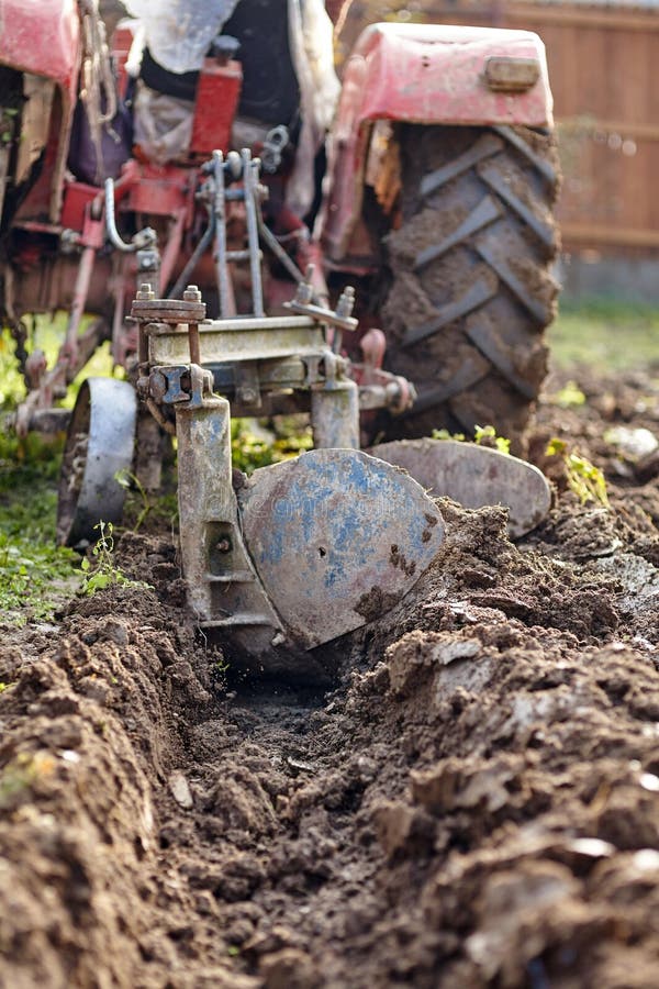 Tractor plowing the land stock image. Image of plowing - 47748147