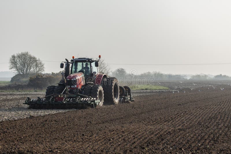 Tractor Plowing the Land in the Morning Editorial Stock Image - Image ...