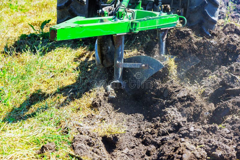 Tractor Plows Field a Cultivates Soil for Spring Planting of Grain ...