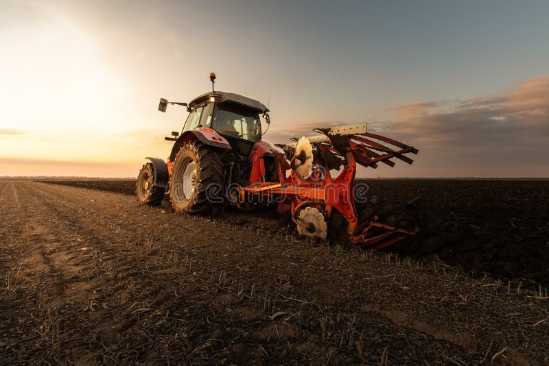 Tractor on the Field during Sunset Stock Photo - Image of plowing ...
