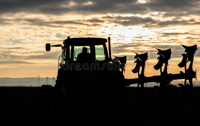 Tractor on the Field during Sunset Stock Photo - Image of machine ...