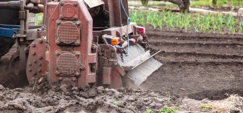 A Tractor Plows the Land on Nature Stock Image - Image of plough ...