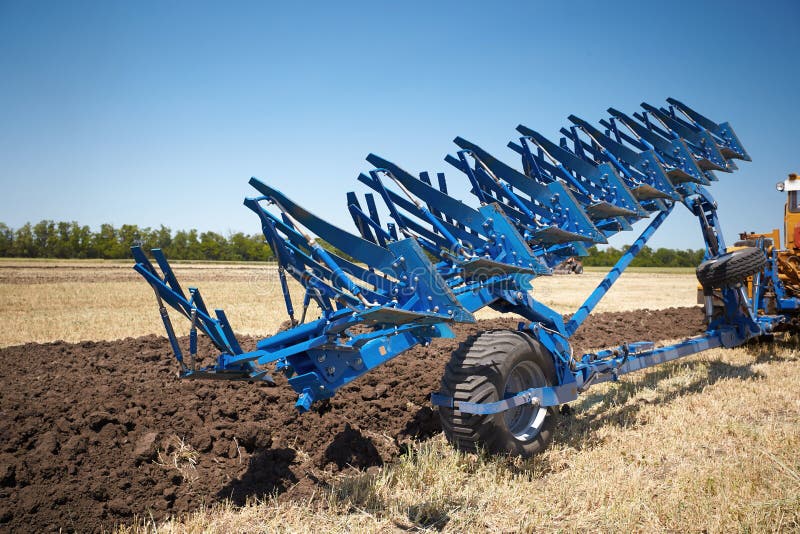 Tractor Plows a Piece of Land in a Field Stock Photo - Image of field ...