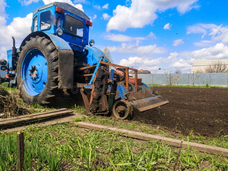 The Tractor Plows the Soil on the Field Stock Photo - Image of harrow ...