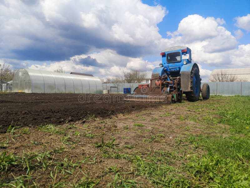 The Tractor Plows the Soil on the Field Stock Image - Image of plowed ...
