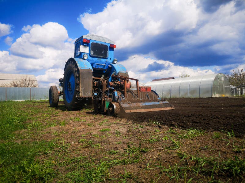 The Tractor Plows the Soil on the Field Stock Photo - Image of ...