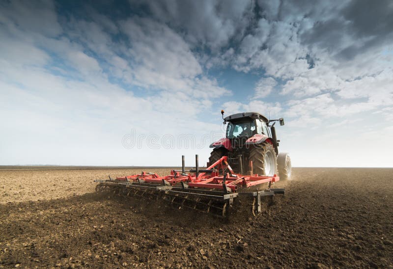Tractor preparing land stock photo. Image of machinery - 68659780