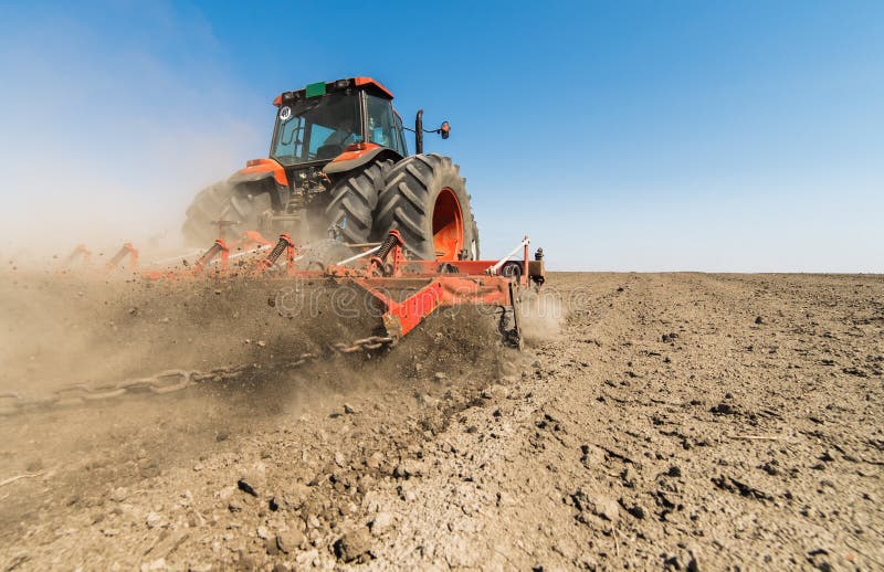 Tractor preparing land stock image. Image of brown, dust - 89948655