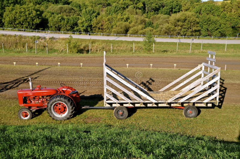 Tractor pulling hay rack editorial stock photo. Image of reunion - 59849613