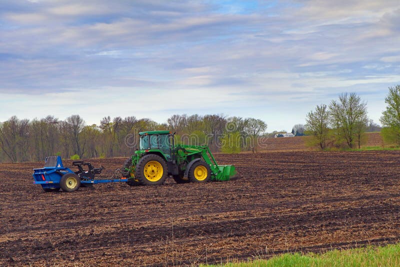 Tractor Pulling a Rock Picker Editorial Photo - Image of simpler, deere ...