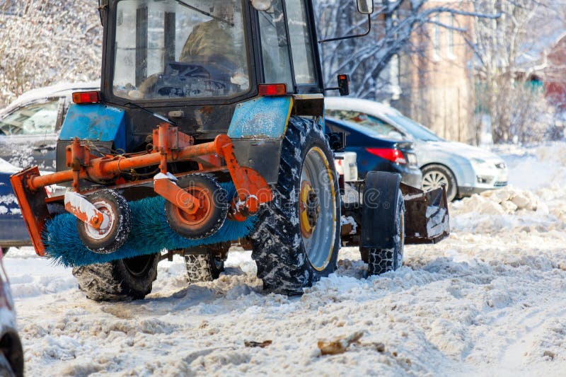 A Tractor is Pulling a Snow Plow Behind it Stock Image - Image of back ...