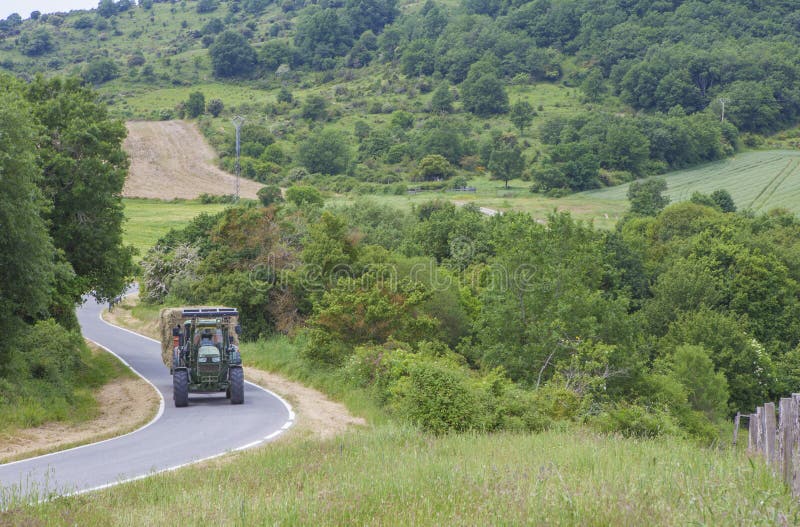 Tractor Pulling Straw Trailer through Local Mountainous Road Stock ...