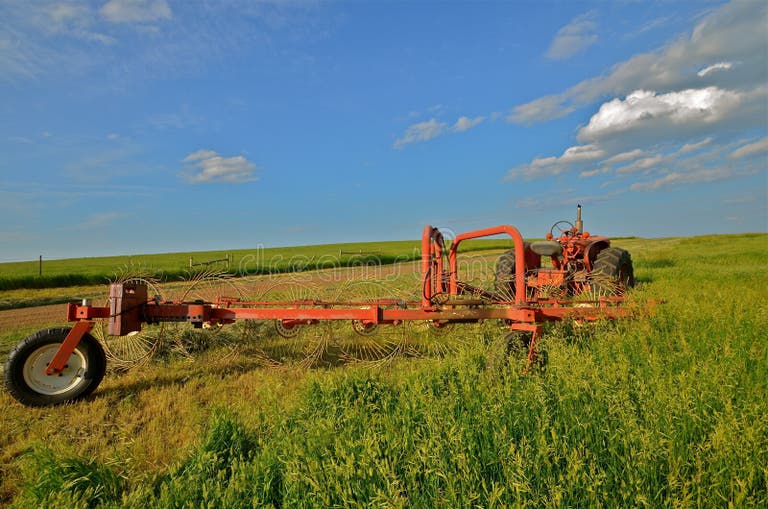 Tractor and Rake Parked in Hay Field Stock Image - Image of parked ...
