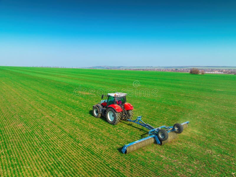 Tractor with a Roller Tillage on Spring Field. Aerial View of Soil ...