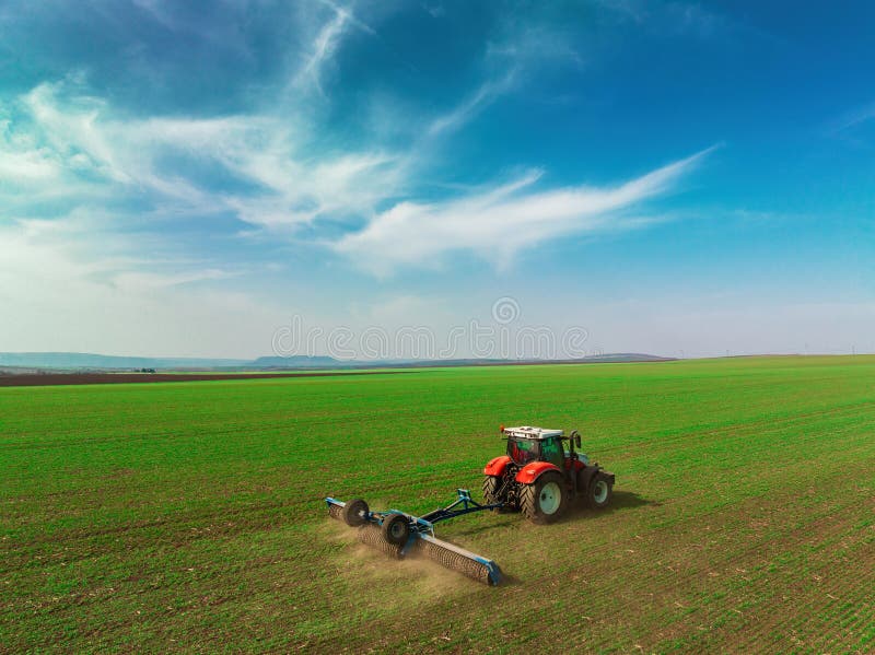 Tractor with a Roller Tillage on Spring Field. Aerial View of Soil ...