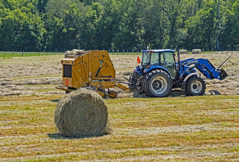 Countryside Rolling Up Hay Bales with a Tractor. Stock Image - Image of ...
