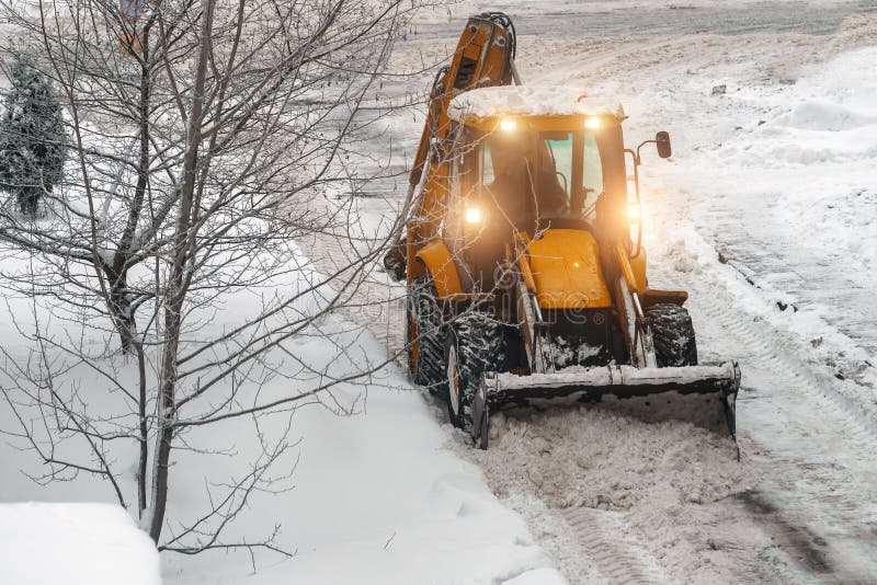 Tractor shoveling snow stock photo. Image of machine - 264170078